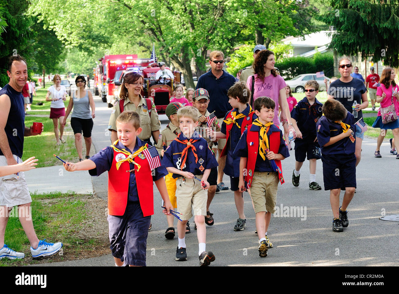 Boy Scout troop handing out pencils during Memorial Day Parade in small ...