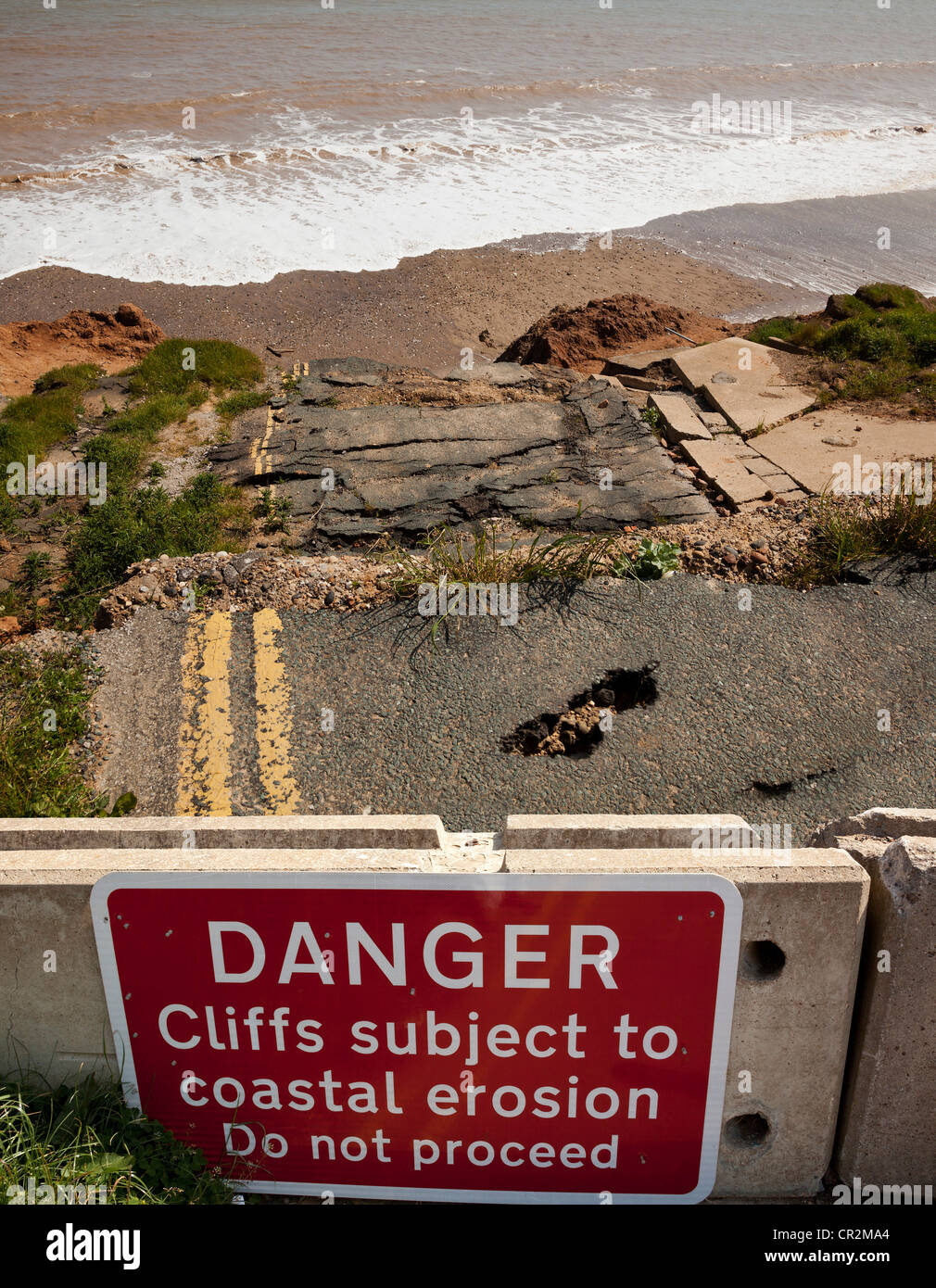 Road and cliffs collapsing into sea, east coast of England, with ...