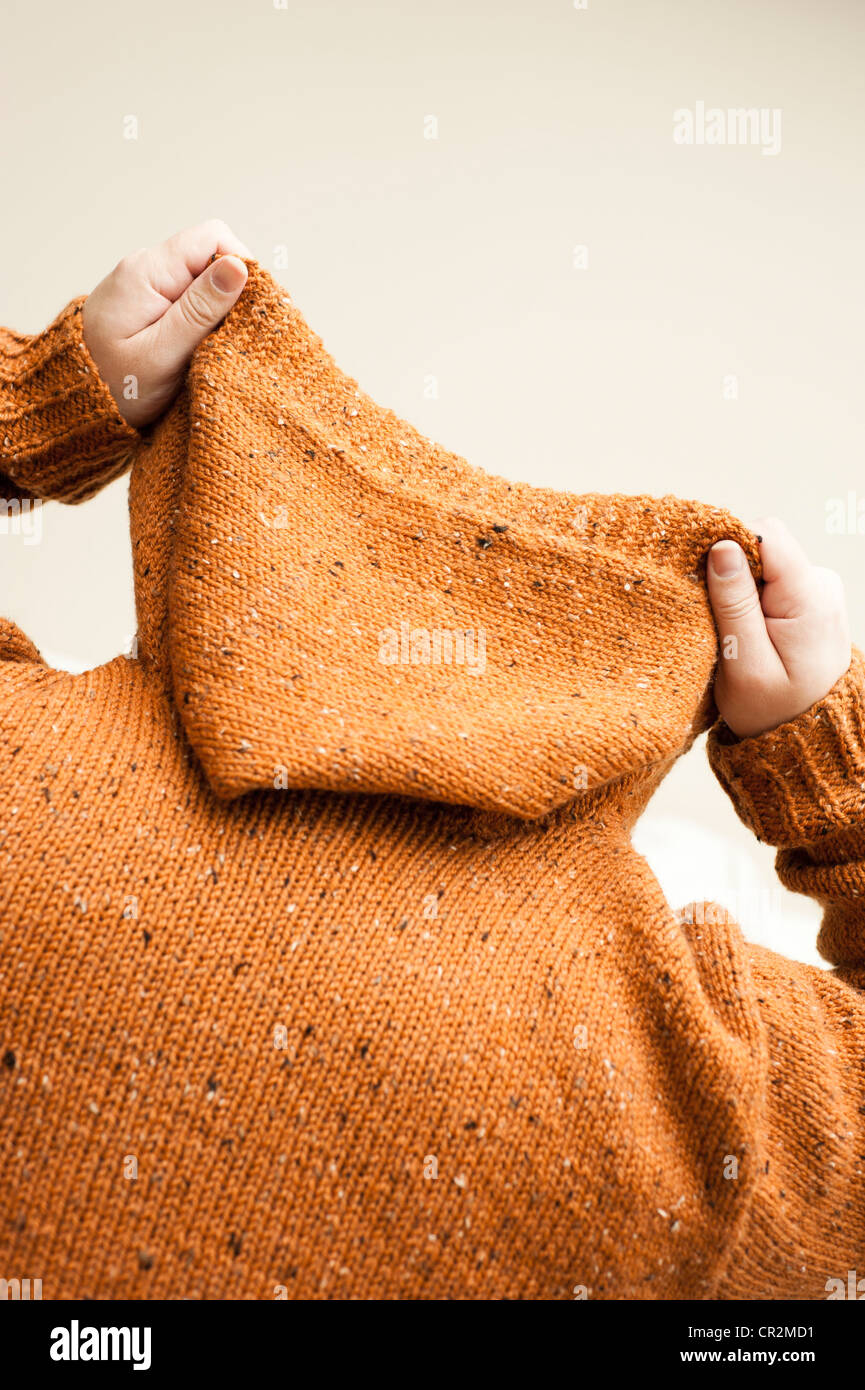 Man pulling up the hood of a jumper Stock Photo - Alamy