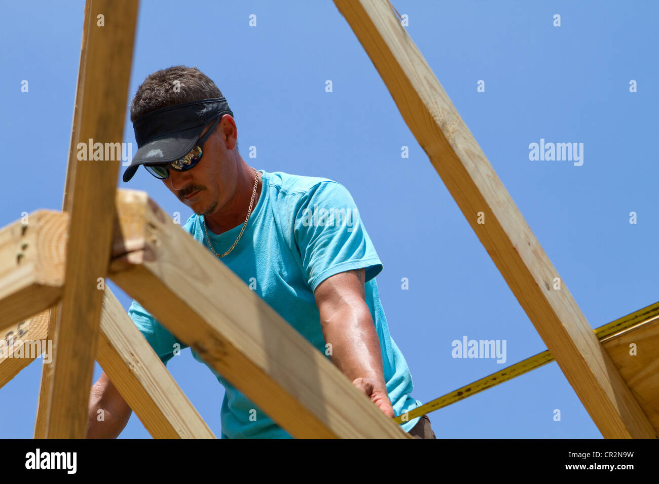 Carpenter uses tape measure calculate hi-res stock photography and ...
