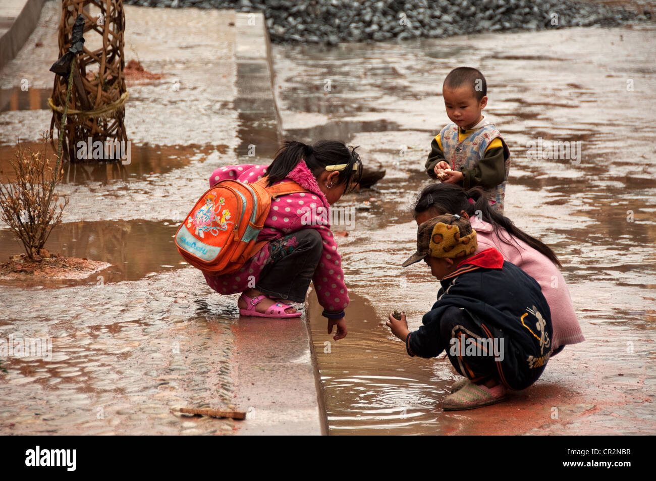 Kids playing in puddle hi-res stock photography and images - Alamy