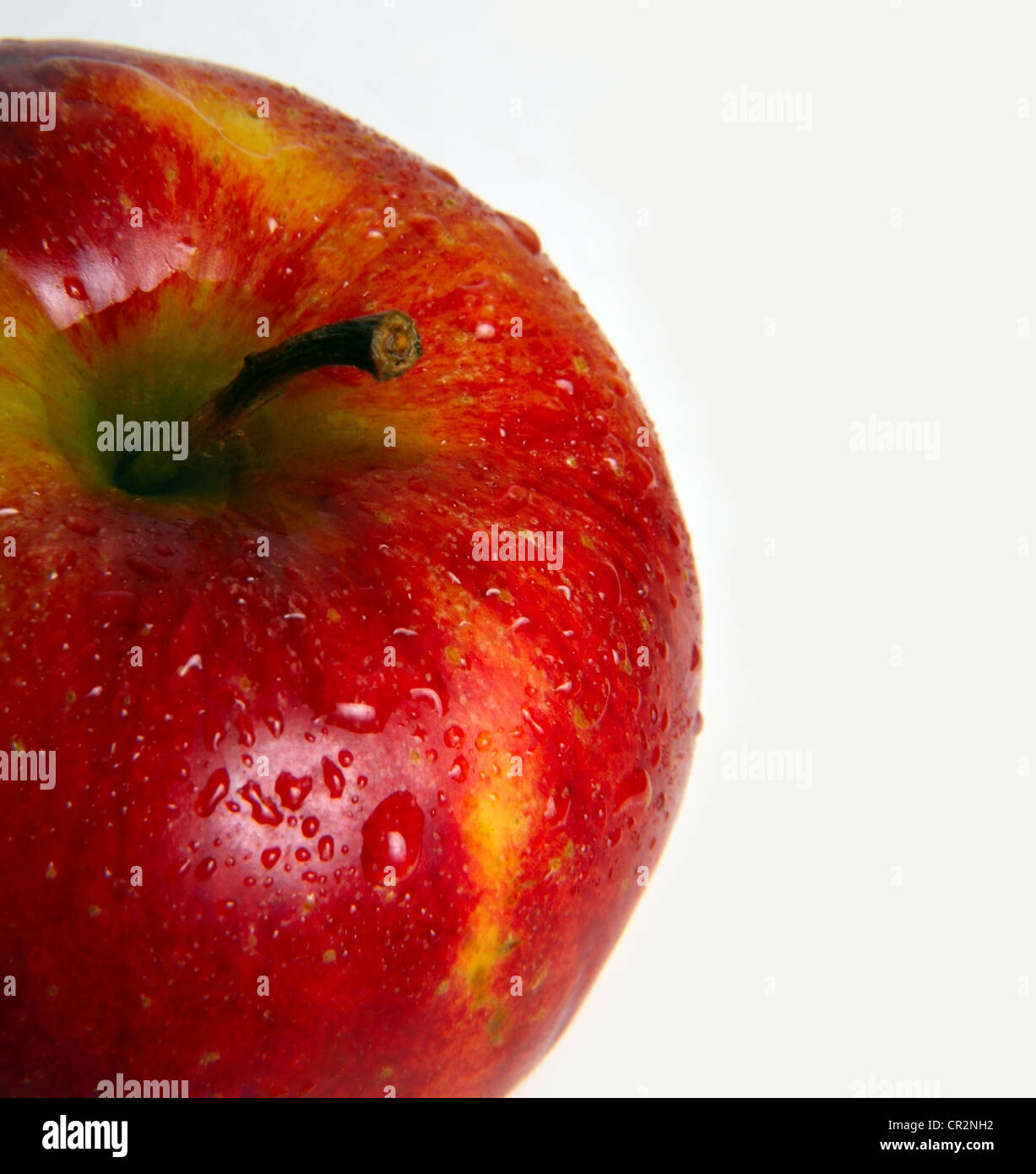 Red apple in drops close-up on a white background Stock Photo - Alamy
