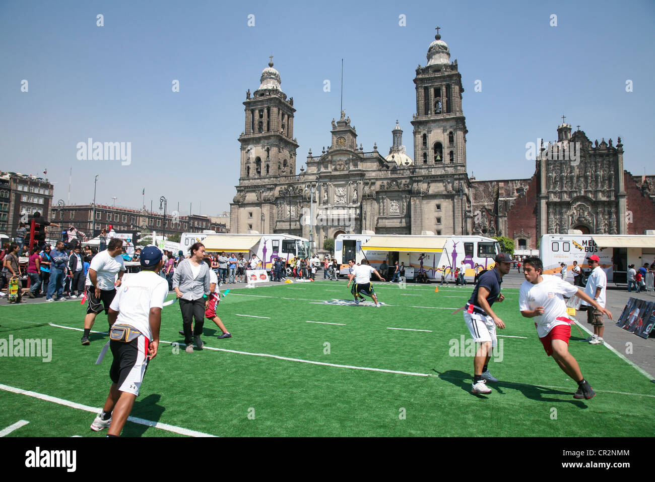 Mexican people play rugby on an artificial field on Zocalo in front of ...