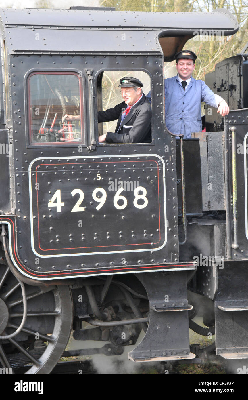 The driver and fireman of 42968 standing on the footplate on sidings at ...