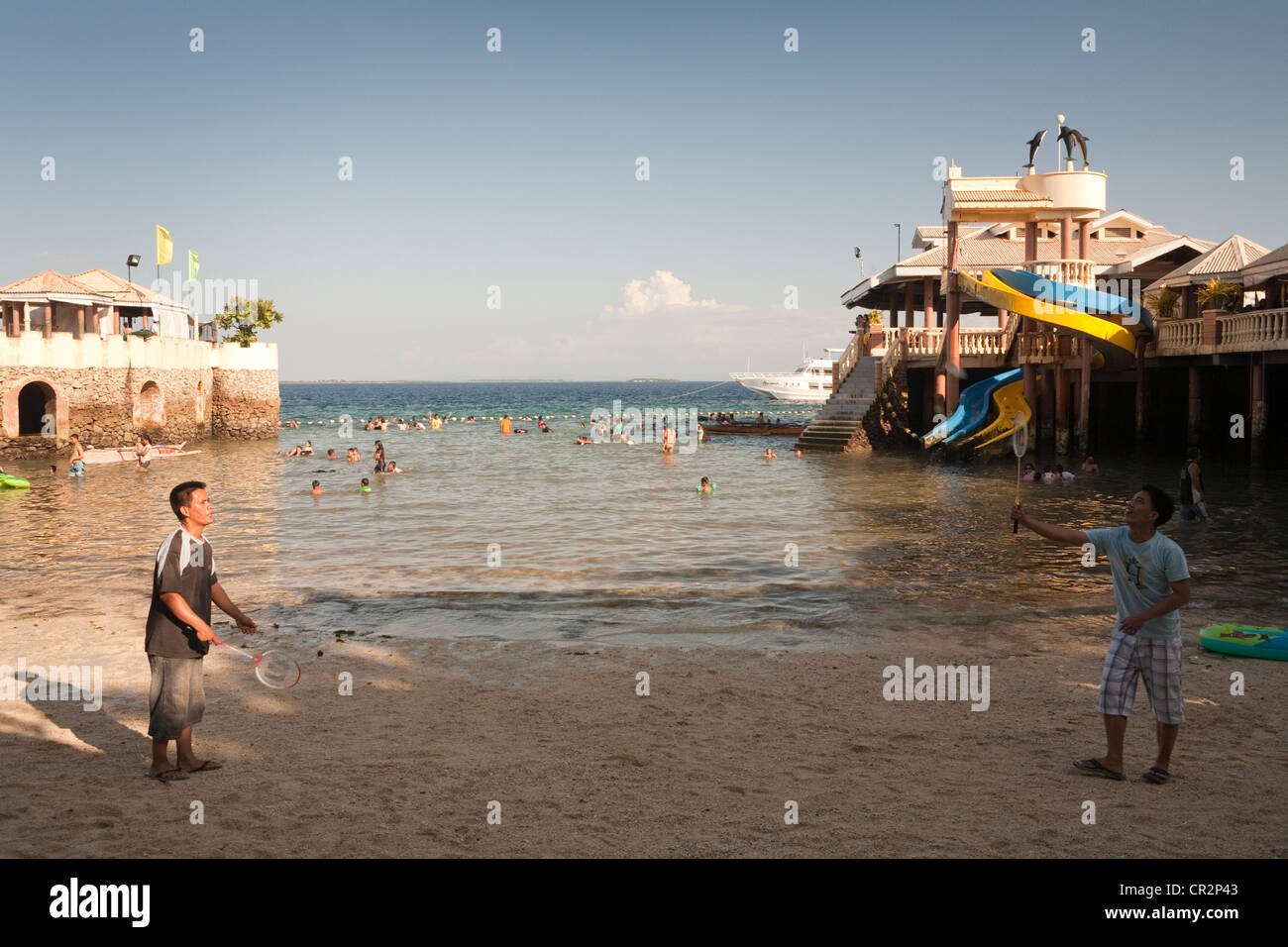 Filipino men playing badminton at Blue Reef Mactan Island Resort. Lapu ...