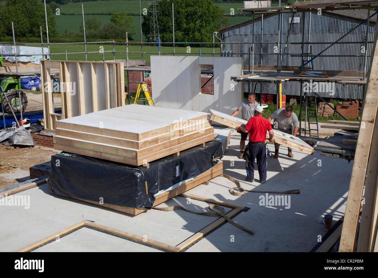 Builders unloading timber frame panels on foundation slab Colemans Hill ...