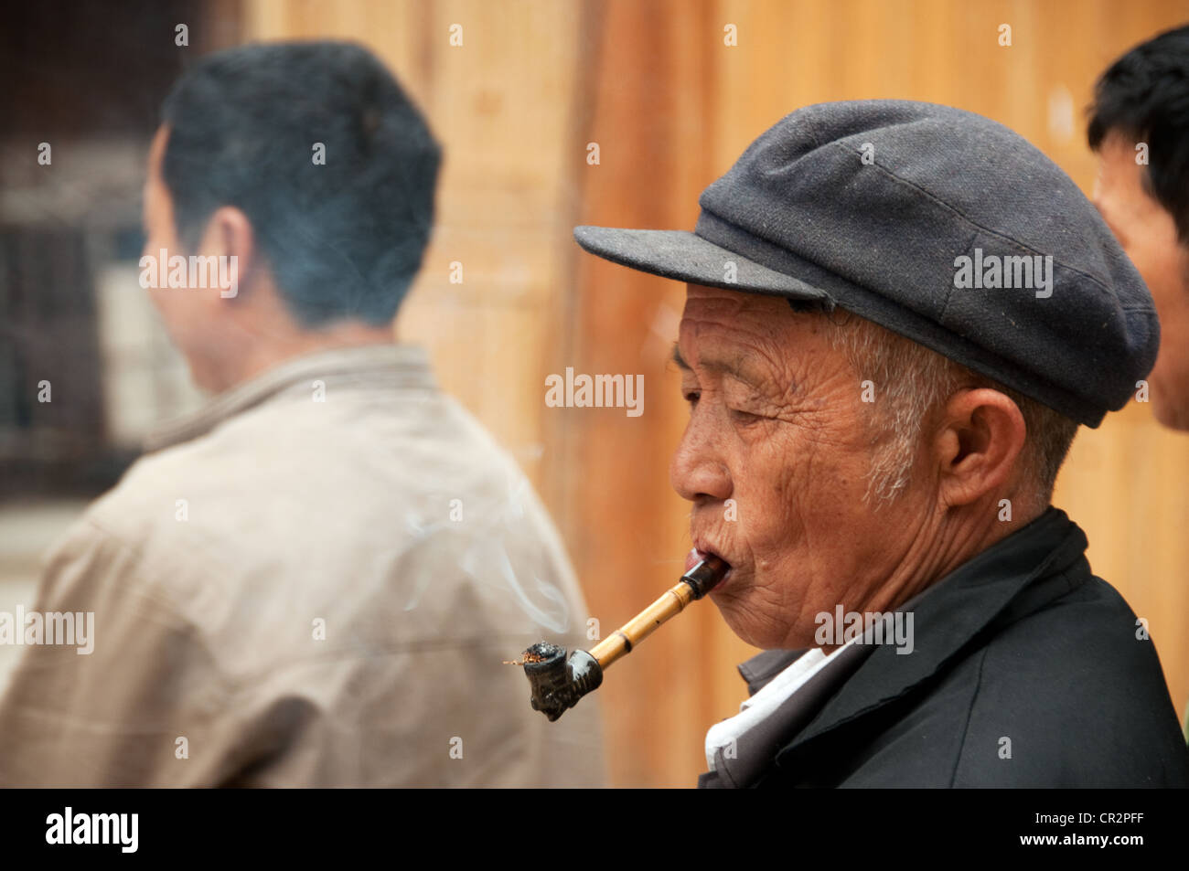 Old chinese man smoking pipe hi-res stock photography and images - Alamy