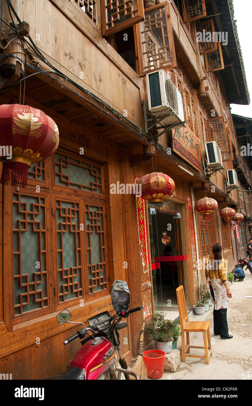 A traditional Dong building with red lanterns and air conditioning ...