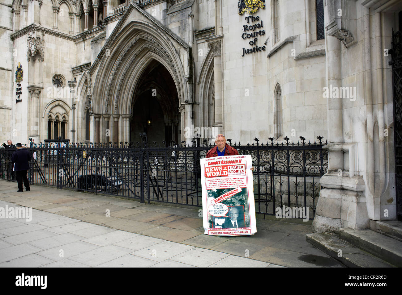 Former News of the World photographer Ian Cutler demonstrates during ...