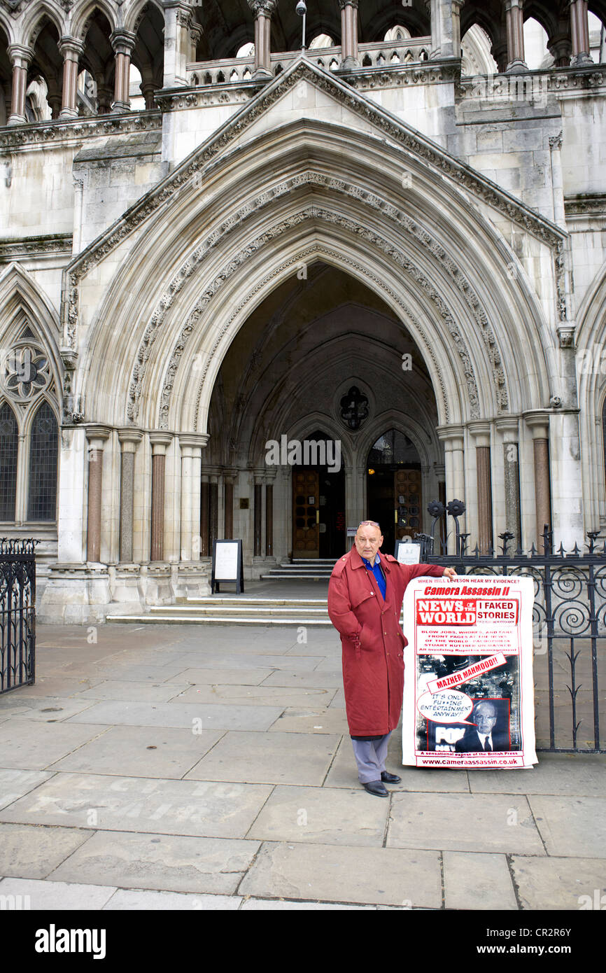 Former News of the World photographer Ian Cutler demonstrates during ...