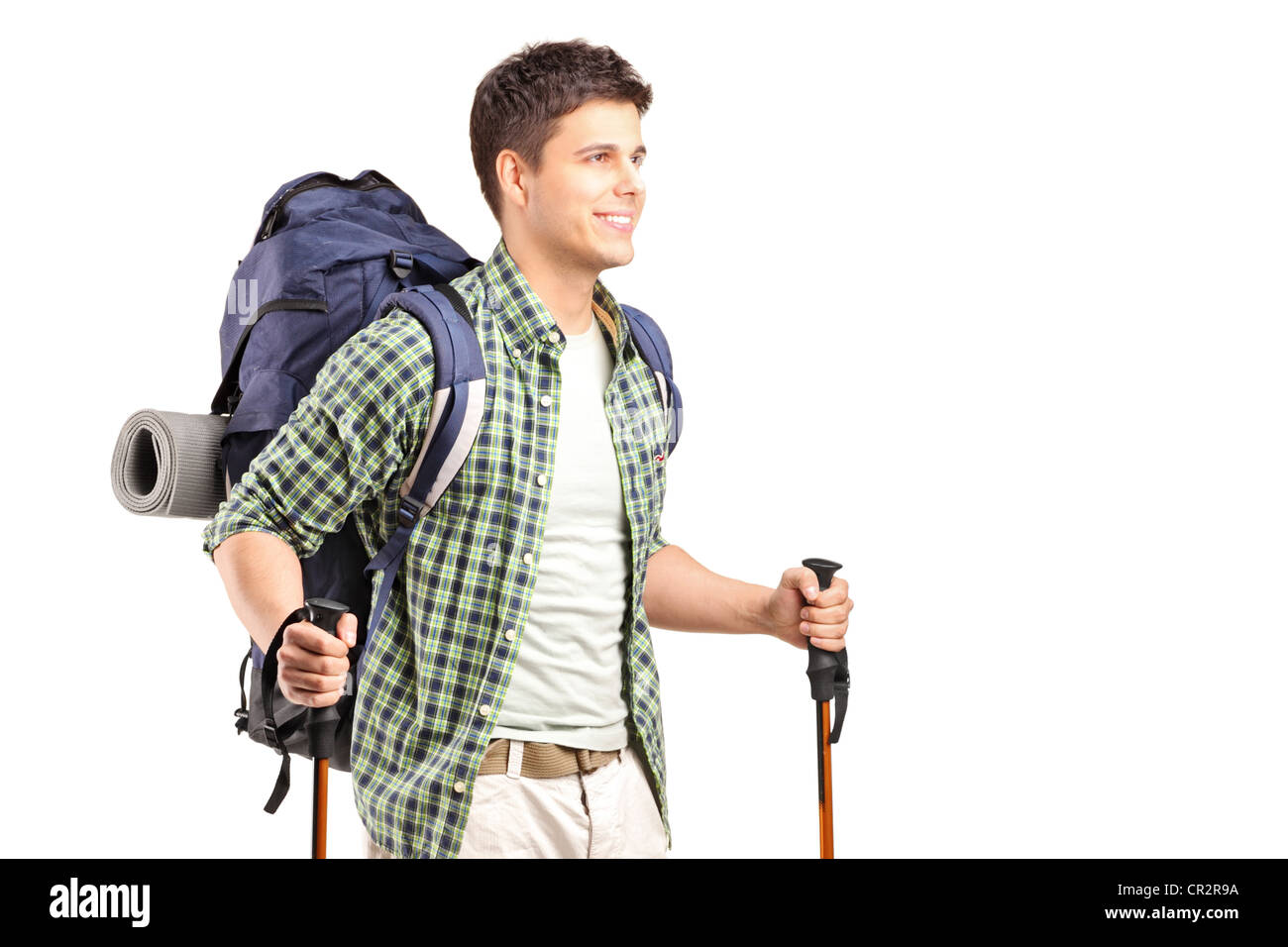 A hiker with backpack holding hiking poles and posing isolated on white ...