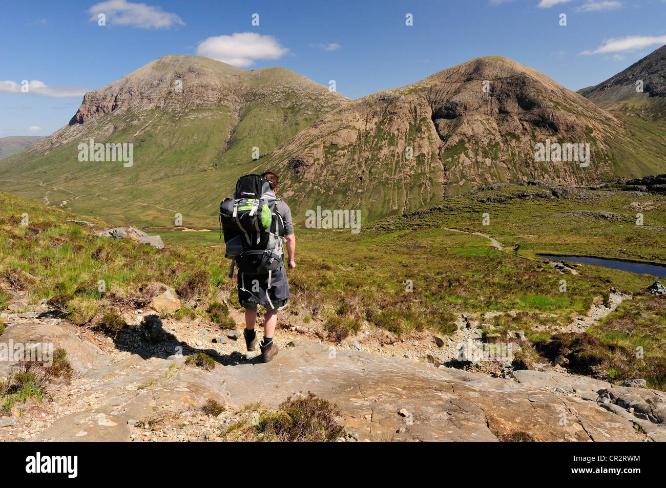 Backpacker descending Druim Hain into Glen Sligachan in summer on the ...
