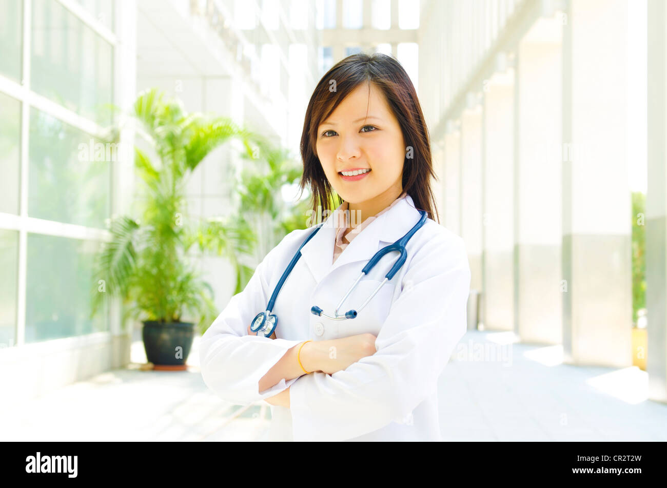 A young medical student standing in front modern building Stock Photo ...