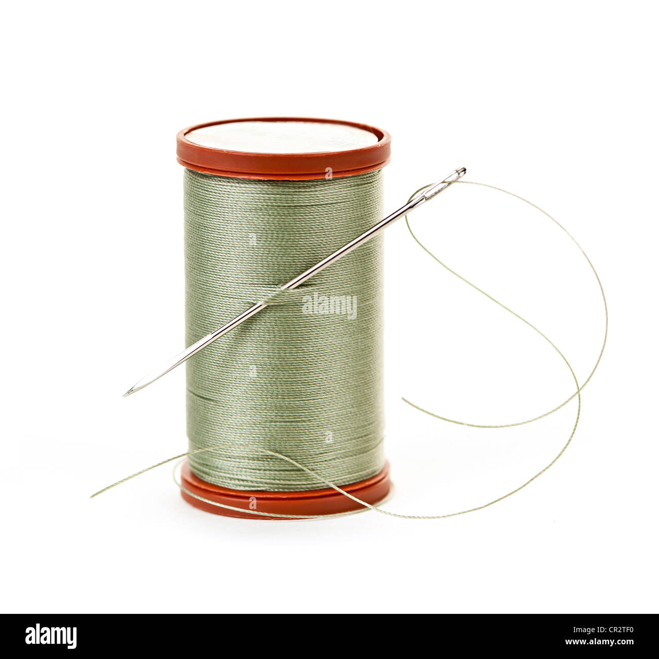Spool of thread with needle for sewing on white background Stock Photo ...