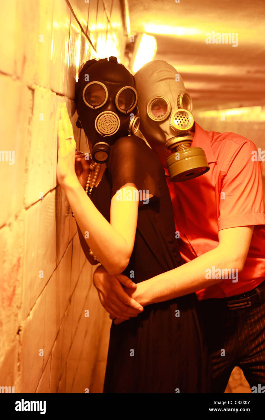 Married couple in gas masks in a tunnel Stock Photo - Alamy