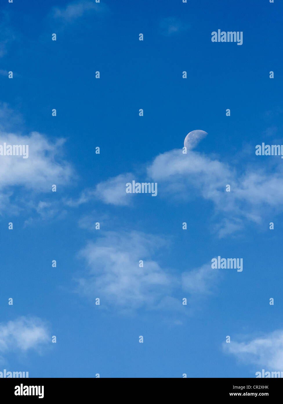 Bright blue morning sky with the half moon and clouds Stock Photo - Alamy