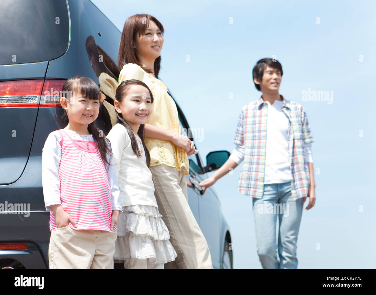 Family of Four By Car Stock Photo - Alamy