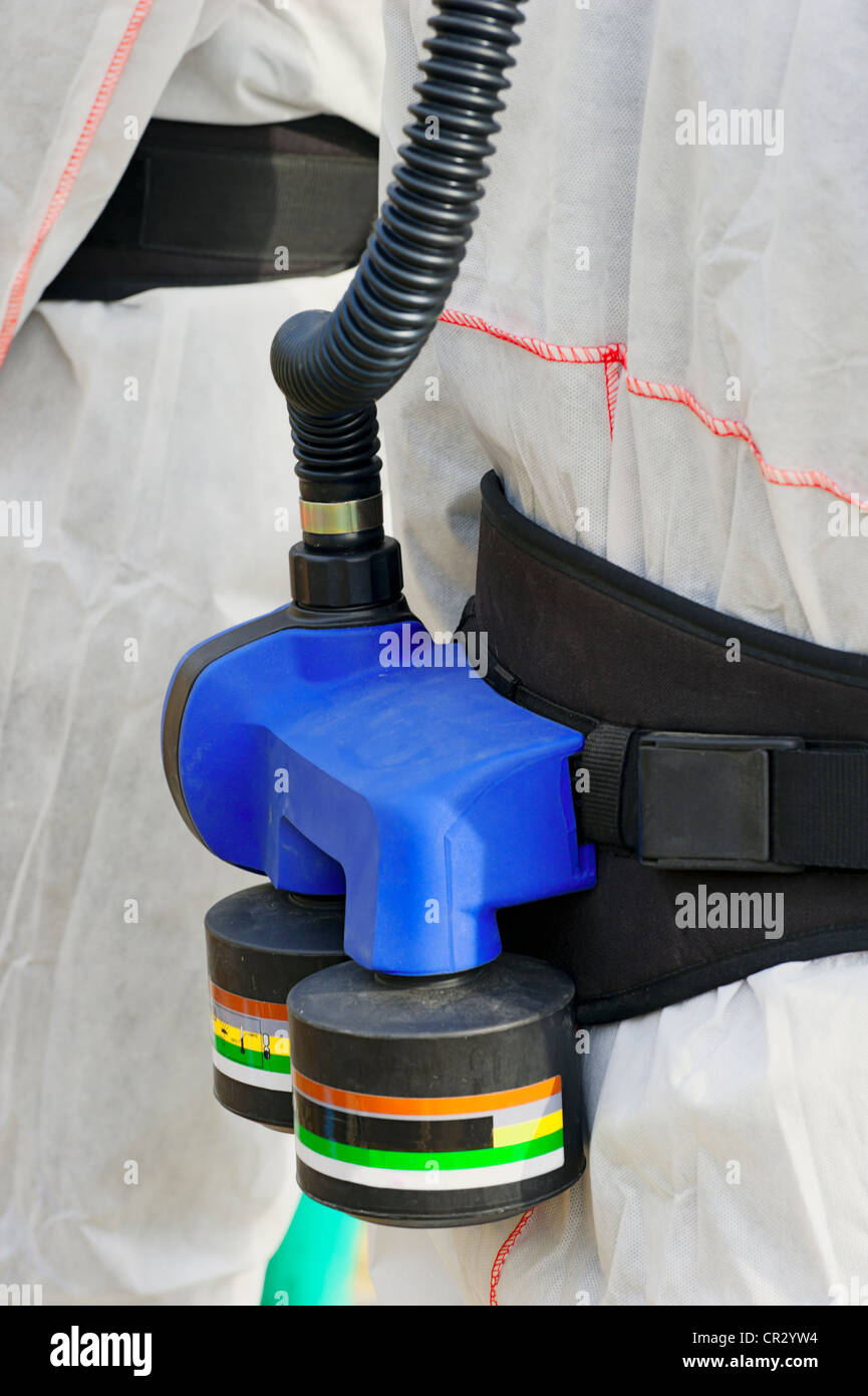 Worker wearing a respiratory protection filter device on a toxic waste ...