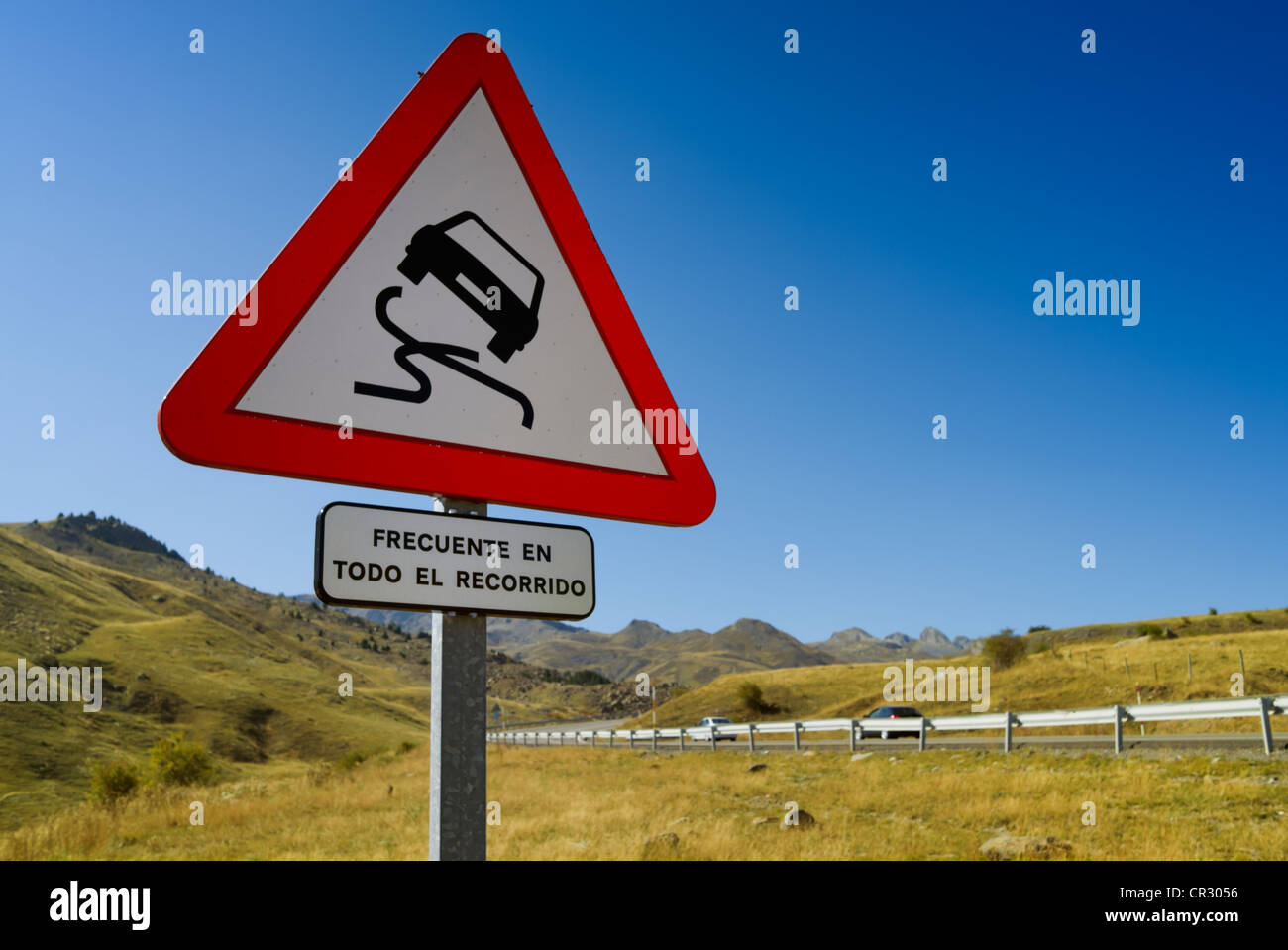 Warning sign, slippery road, on the mountain pass road to El Portalet ...