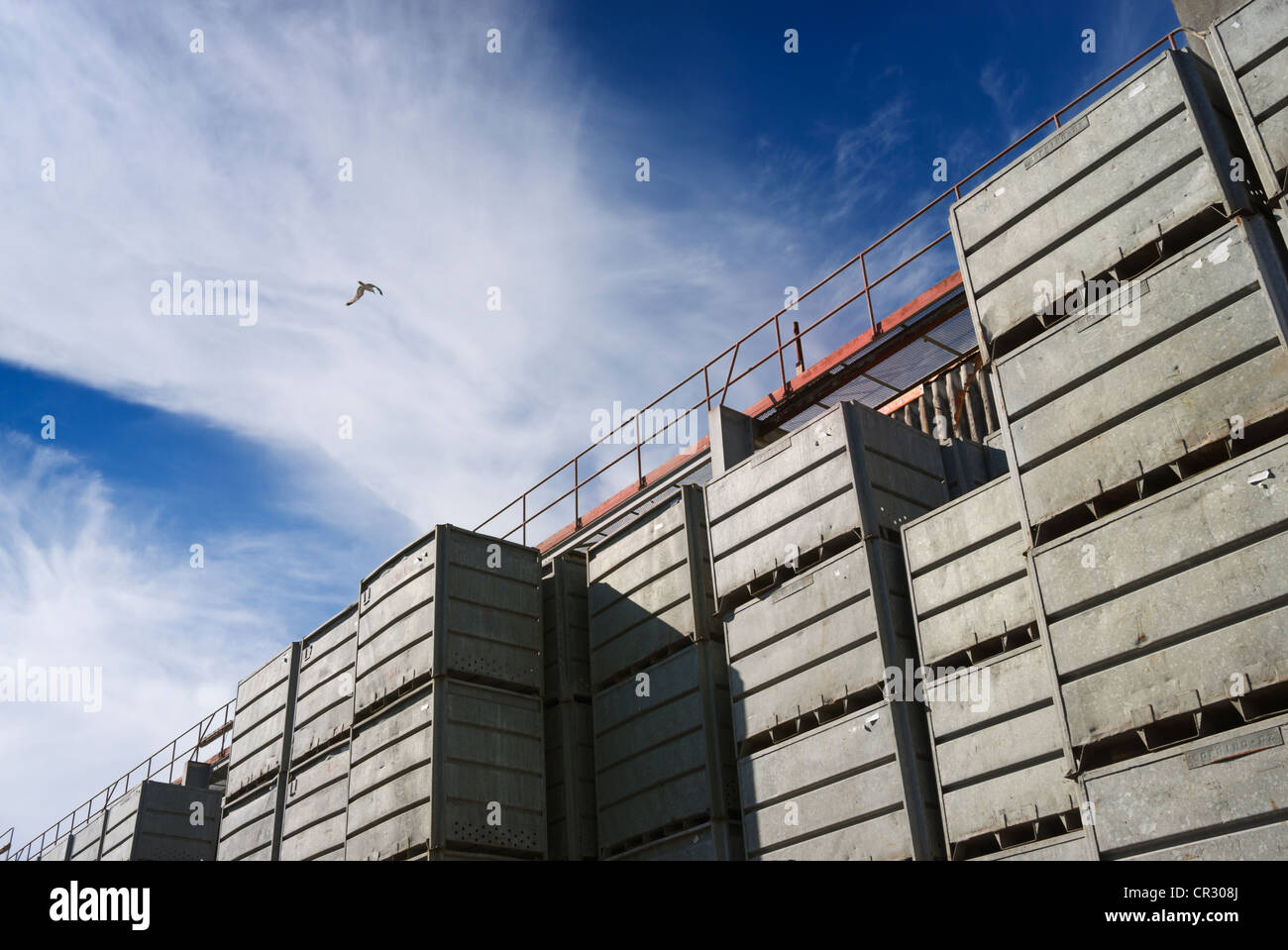 Stacked metal fishing crates, in Douarnenez harbour, Finistere ...