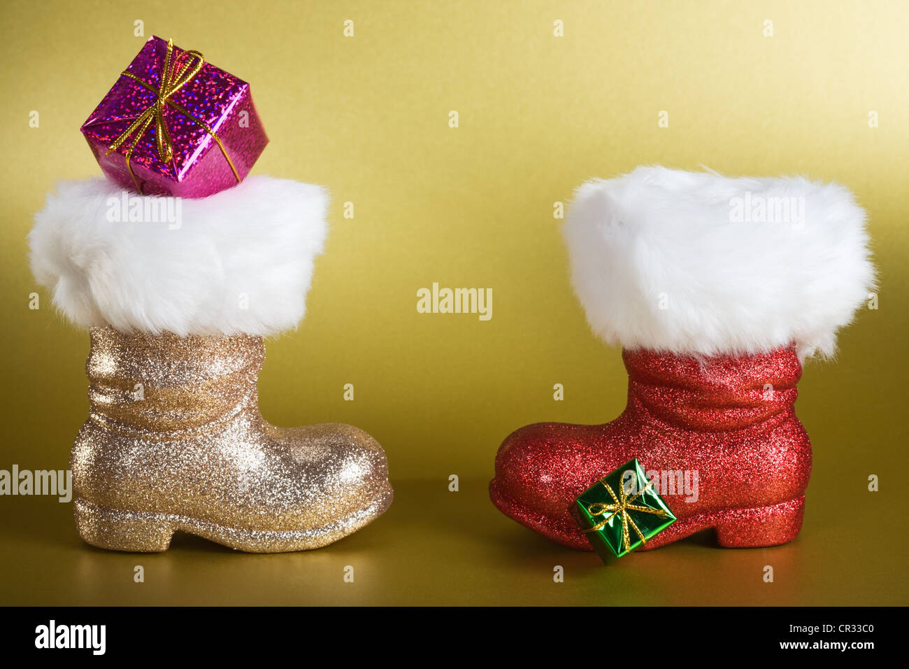 Santa boots with gift box on gold background Stock Photo - Alamy
