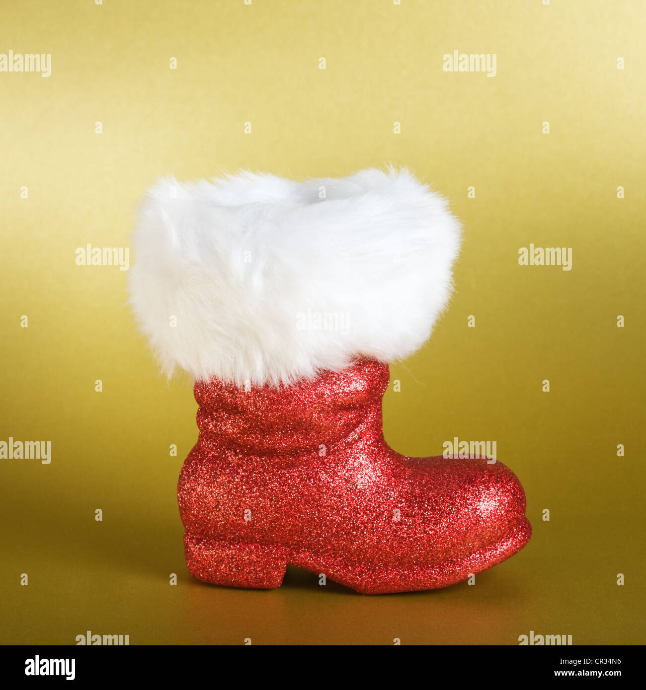 Red Santa boot on gold background Stock Photo - Alamy