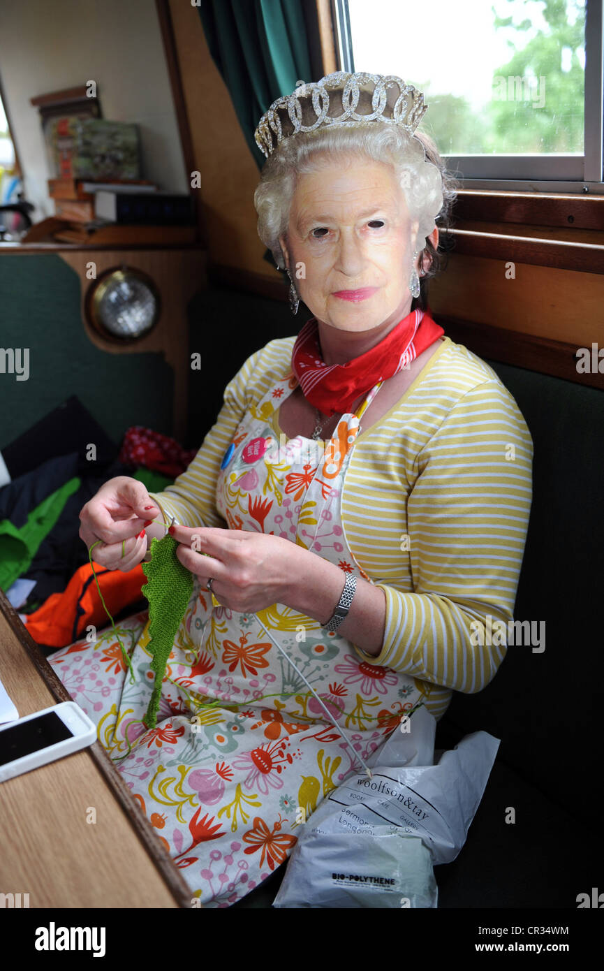 Knitter wearing her majesty THE QUEEN face mask on a canal boat holiday ...