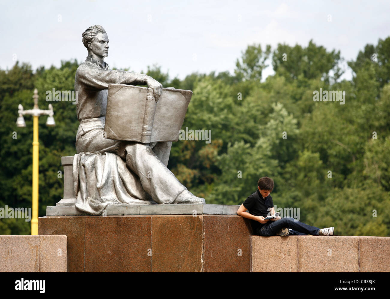 The student reads the book near to a statue Stock Photo - Alamy