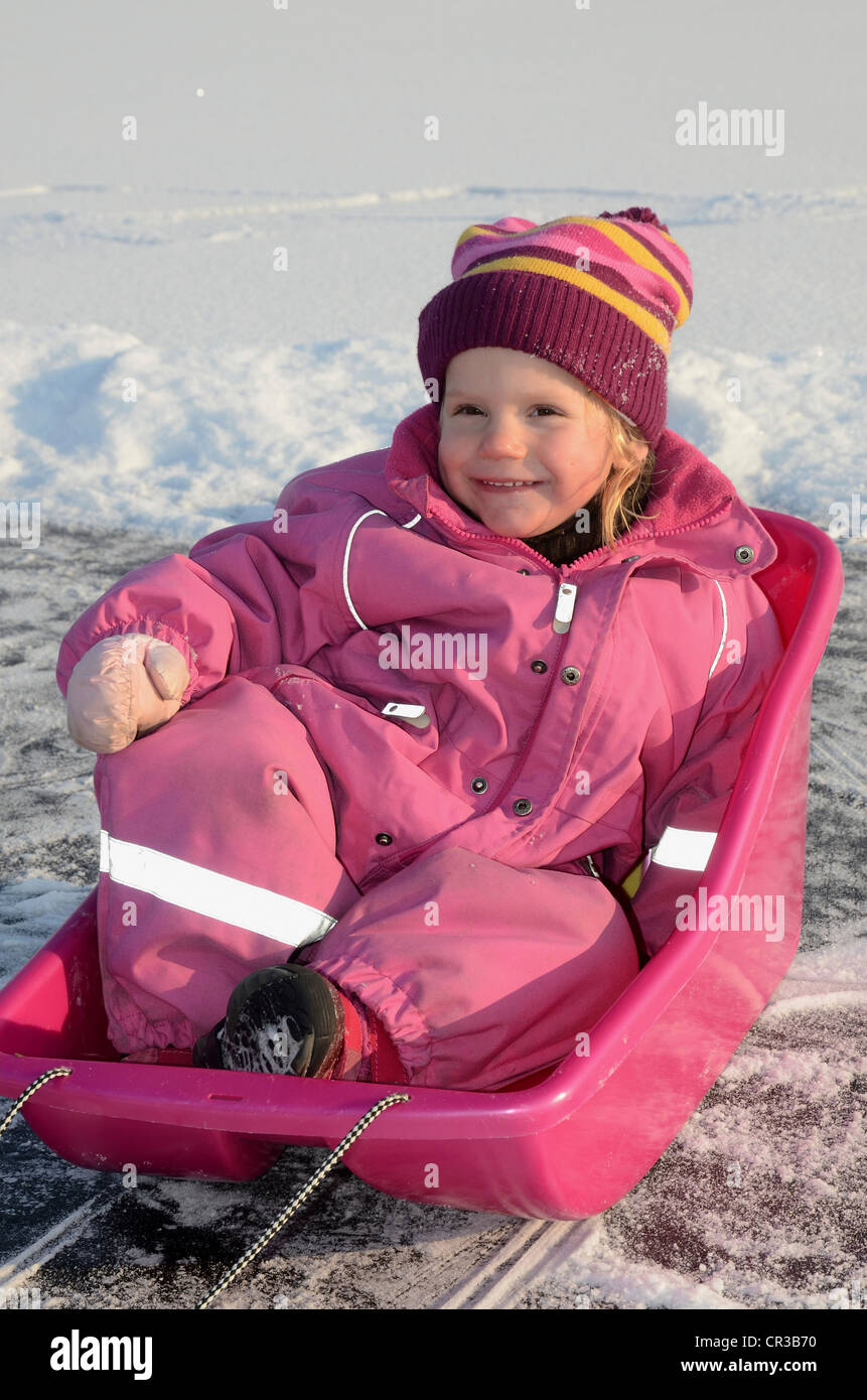 Little girl, two years, in a pink sledge, Hedeskoga, Skåne, Skane ...
