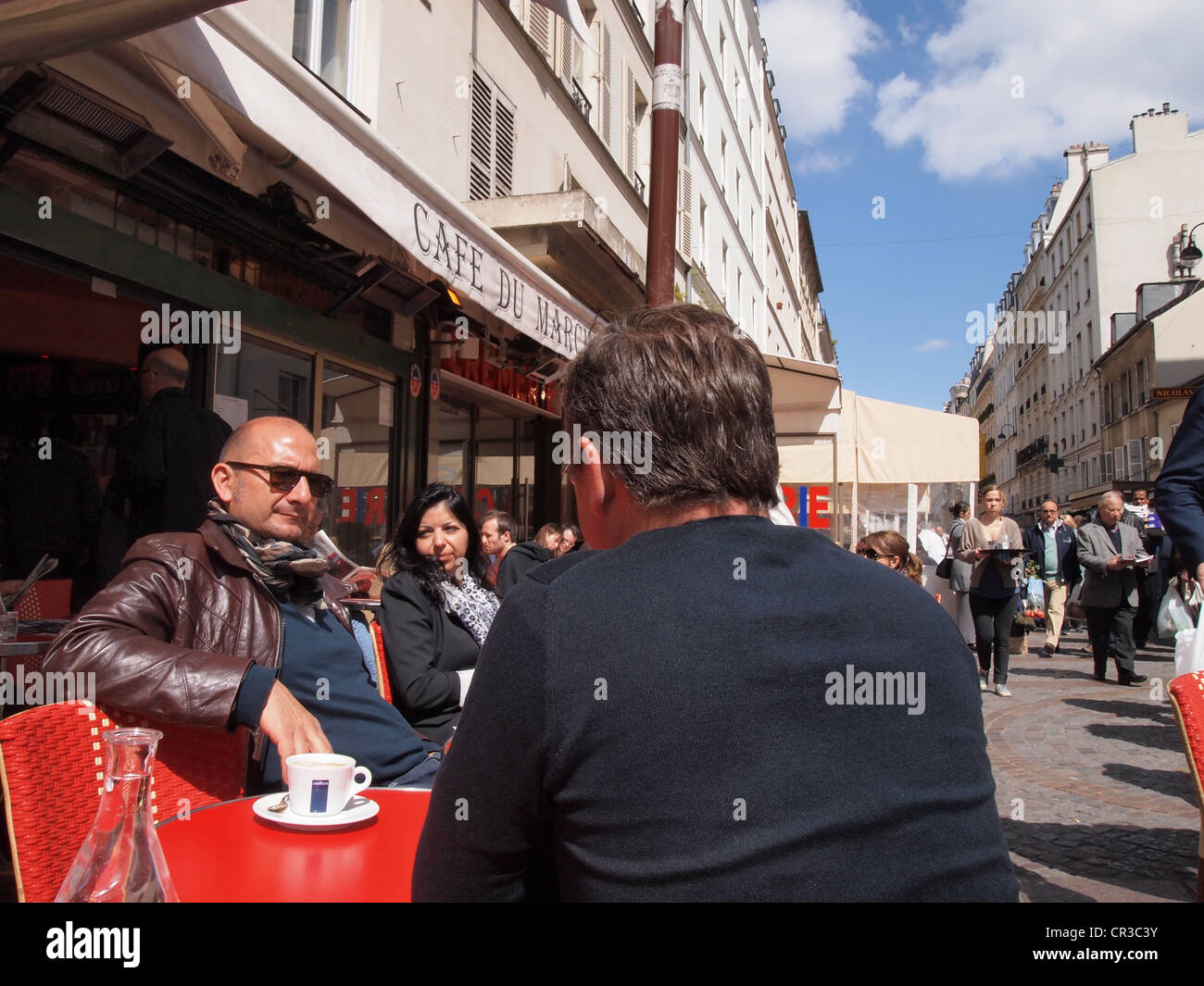 People enjoying cafe at a bistro on Rue Cler in Paris, France, May 13 ...