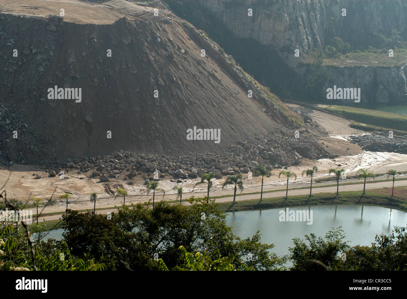 Mountain of sand and rock and pool in a quarry Stock Photo - Alamy