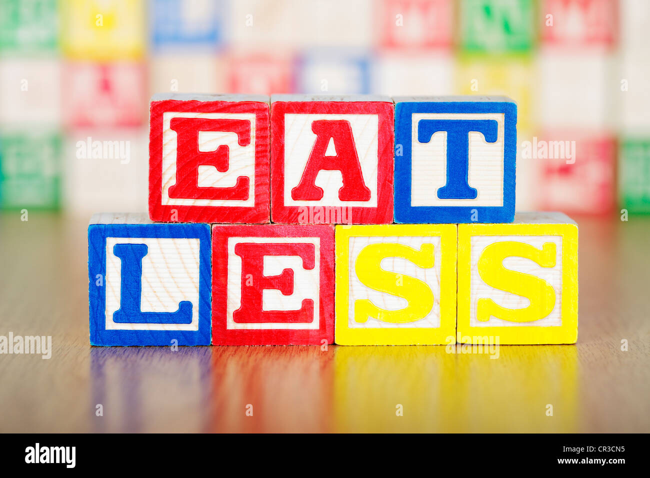 Eat Less Spelled Out in Alphabet Building Blocks Stock Photo - Alamy