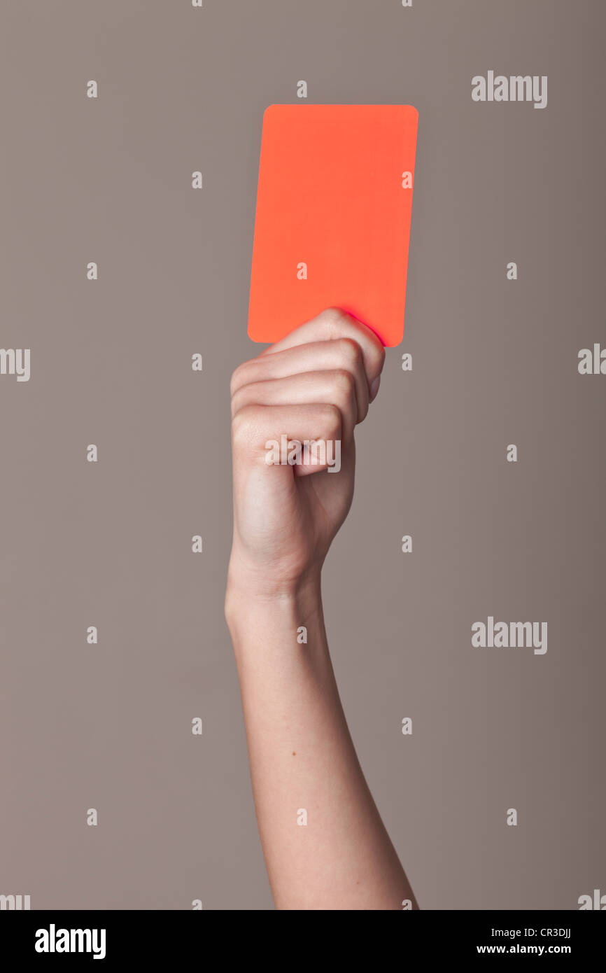 Red card held by female hand Stock Photo - Alamy