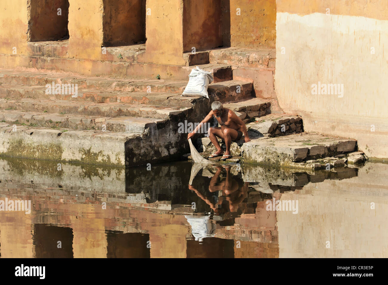 Indian man washing clothes hi-res stock photography and images - Alamy