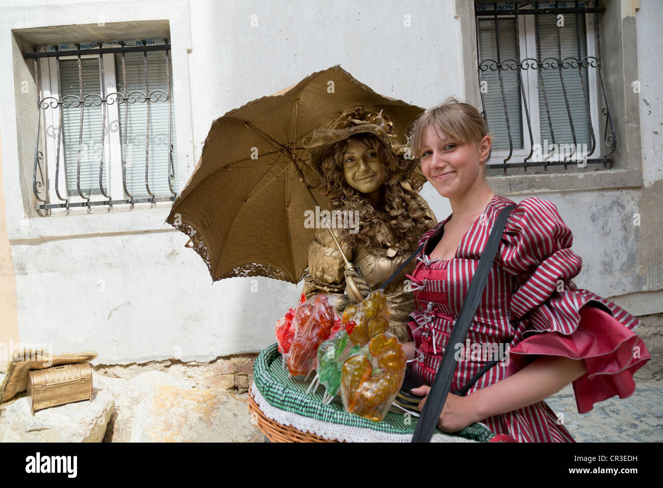 A female street performer and a female street seller during a break ...