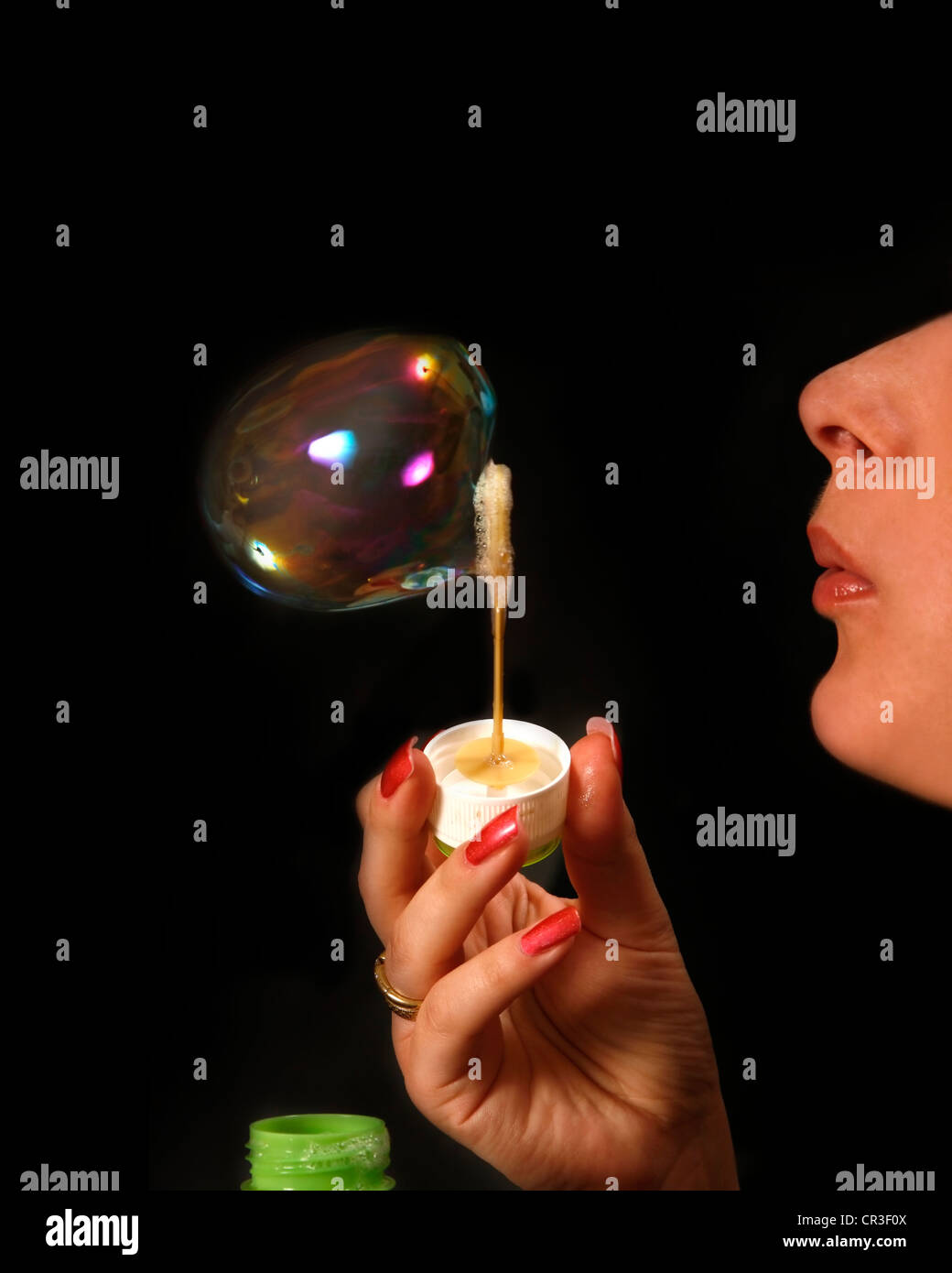 Profile of the woman inflating a soap bubble Stock Photo - Alamy