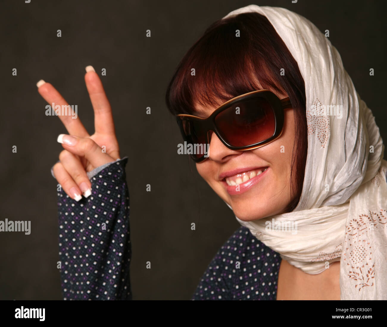The girl in solar glasses with gesture a victory close-up Stock Photo ...