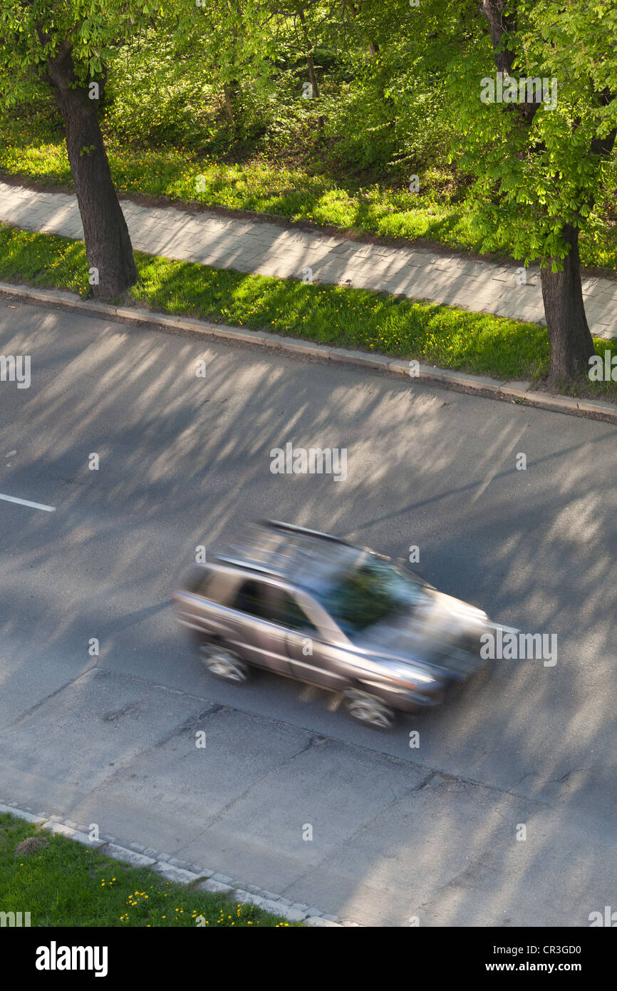 Speeding concept - Cars moving fast on a road on a lovely sunny day ...
