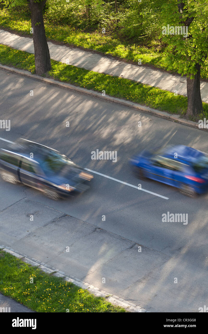Speeding concept - Cars moving fast on a road on a lovely sunny day ...
