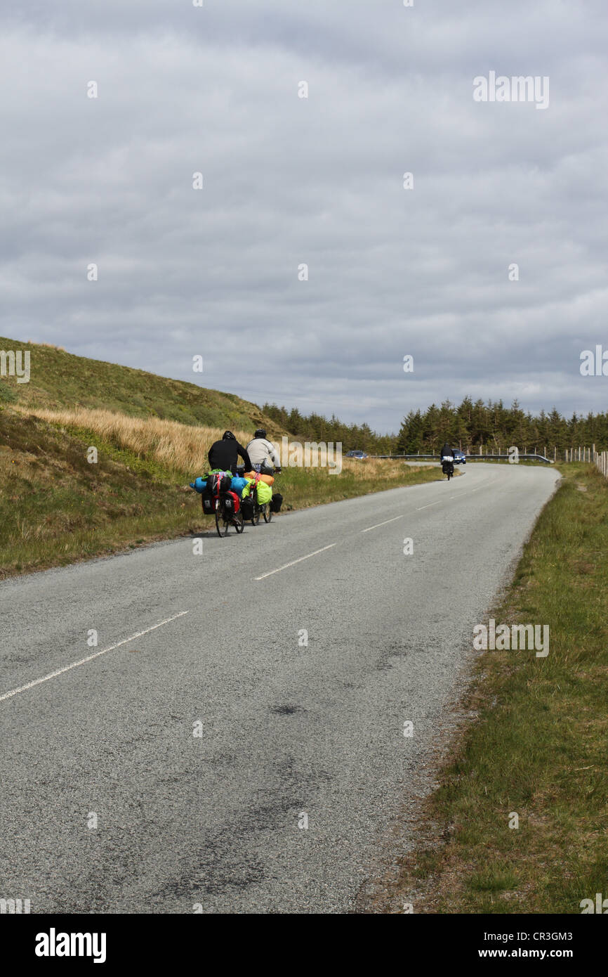 Heavily laden cyclists on A855 Trotternish Isle of Skye Scotland June ...