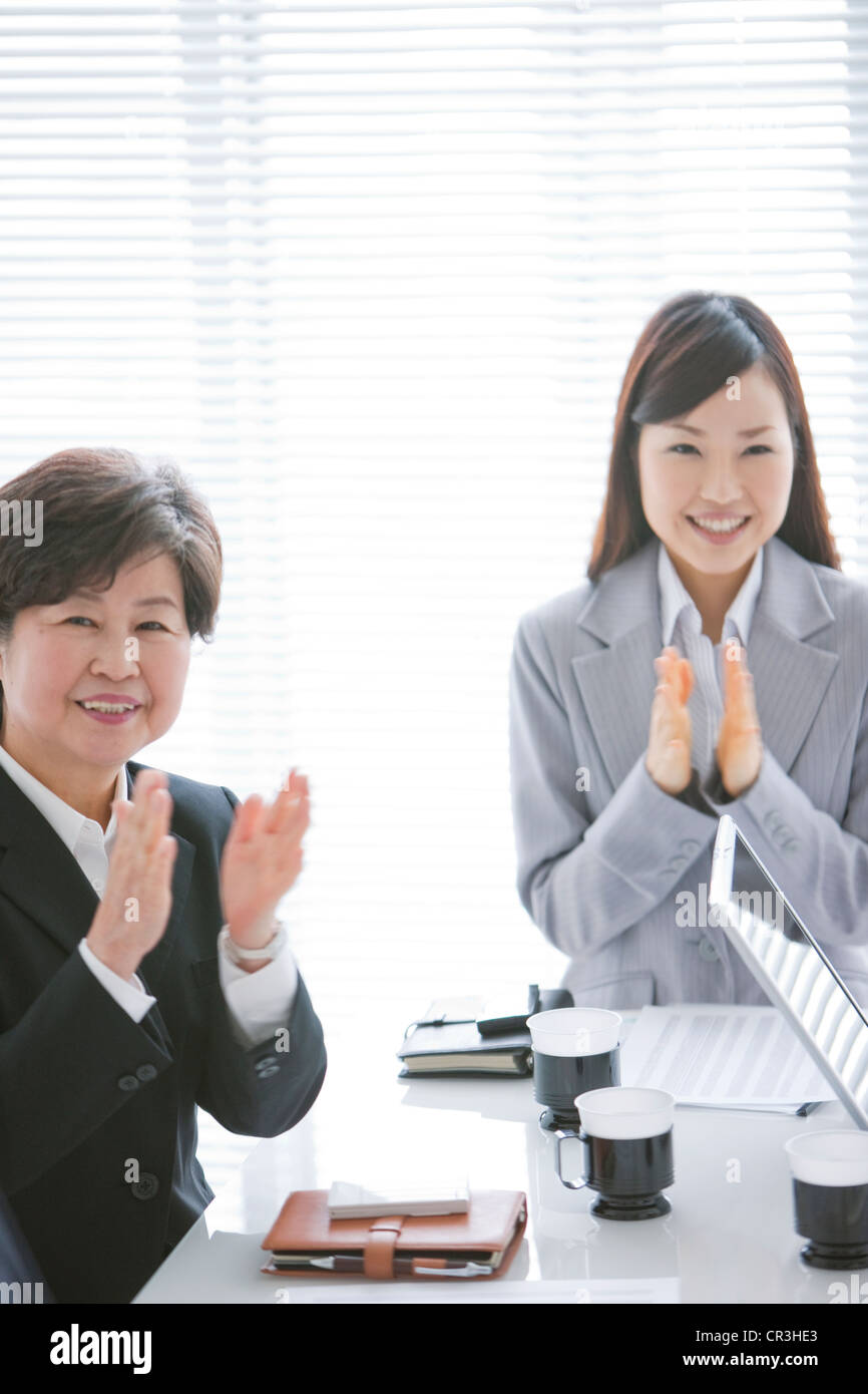 Two Businesswomen Clapping Stock Photo - Alamy