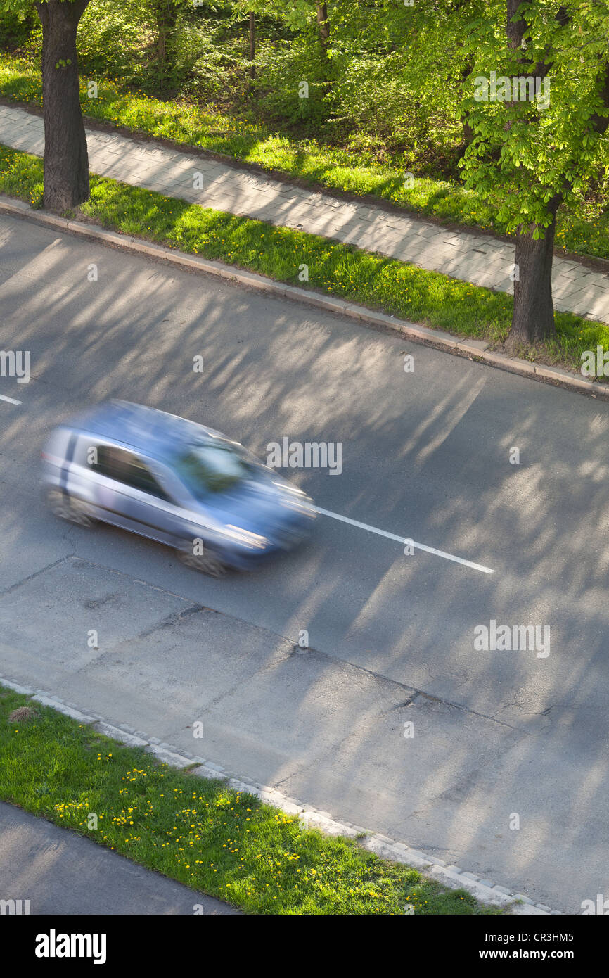 Speeding concept - Cars moving fast on a road on a lovely sunny day ...