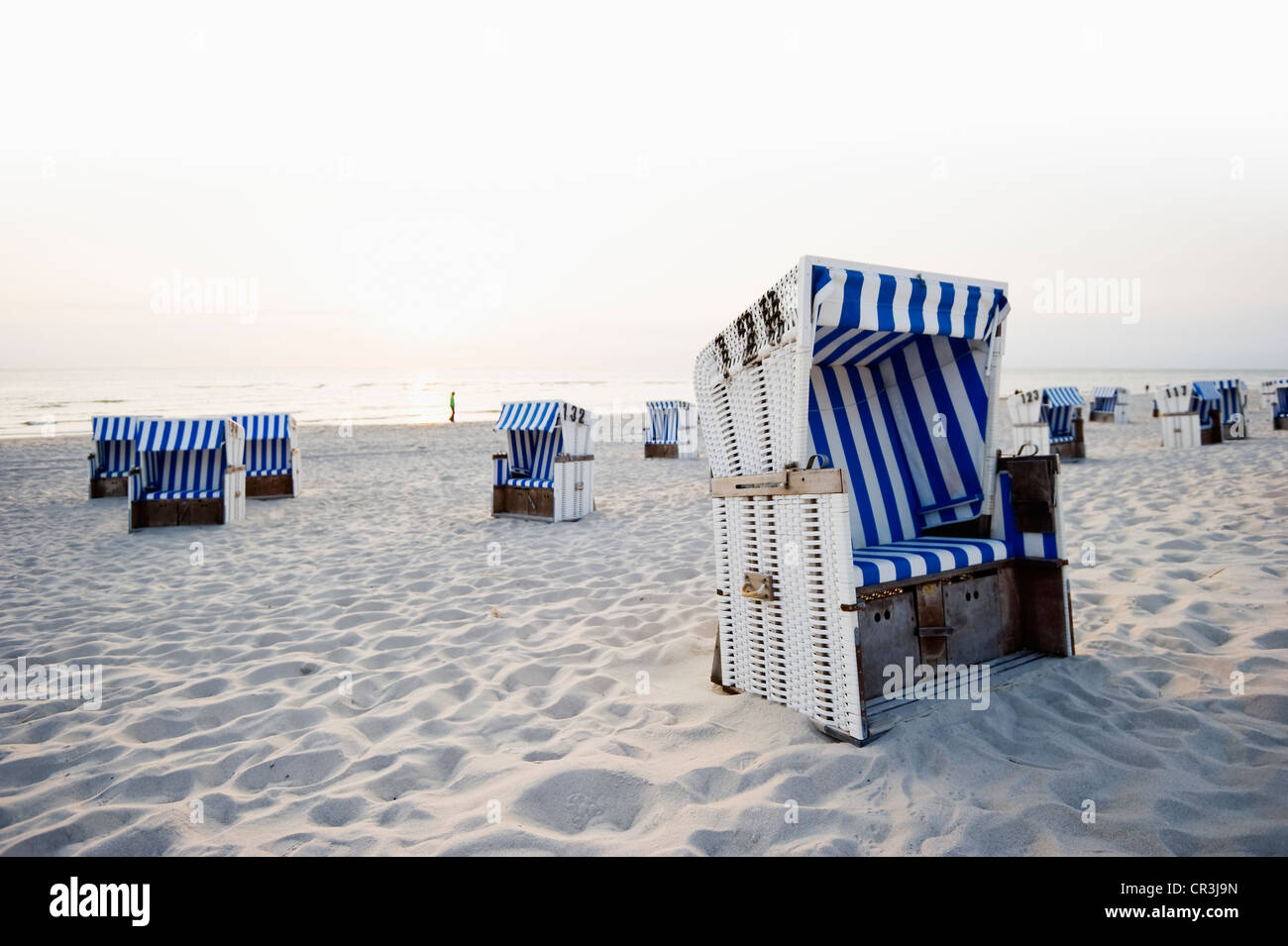 Roofed wicker beach chairs on the beach of Westerland, Sylt island ...