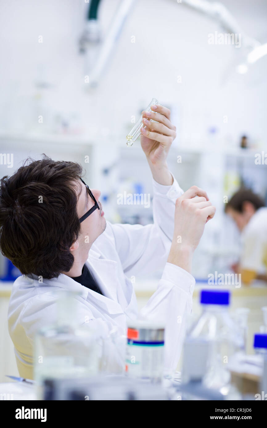 young male researcher carrying out scientific research in a chemistry ...