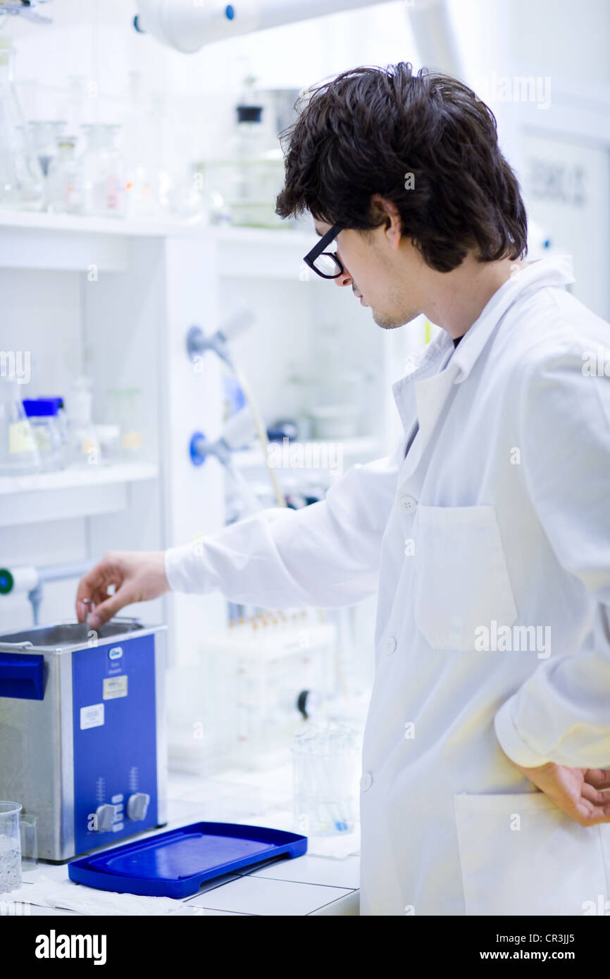 young male researcher carrying out scientific research in a chemistry ...