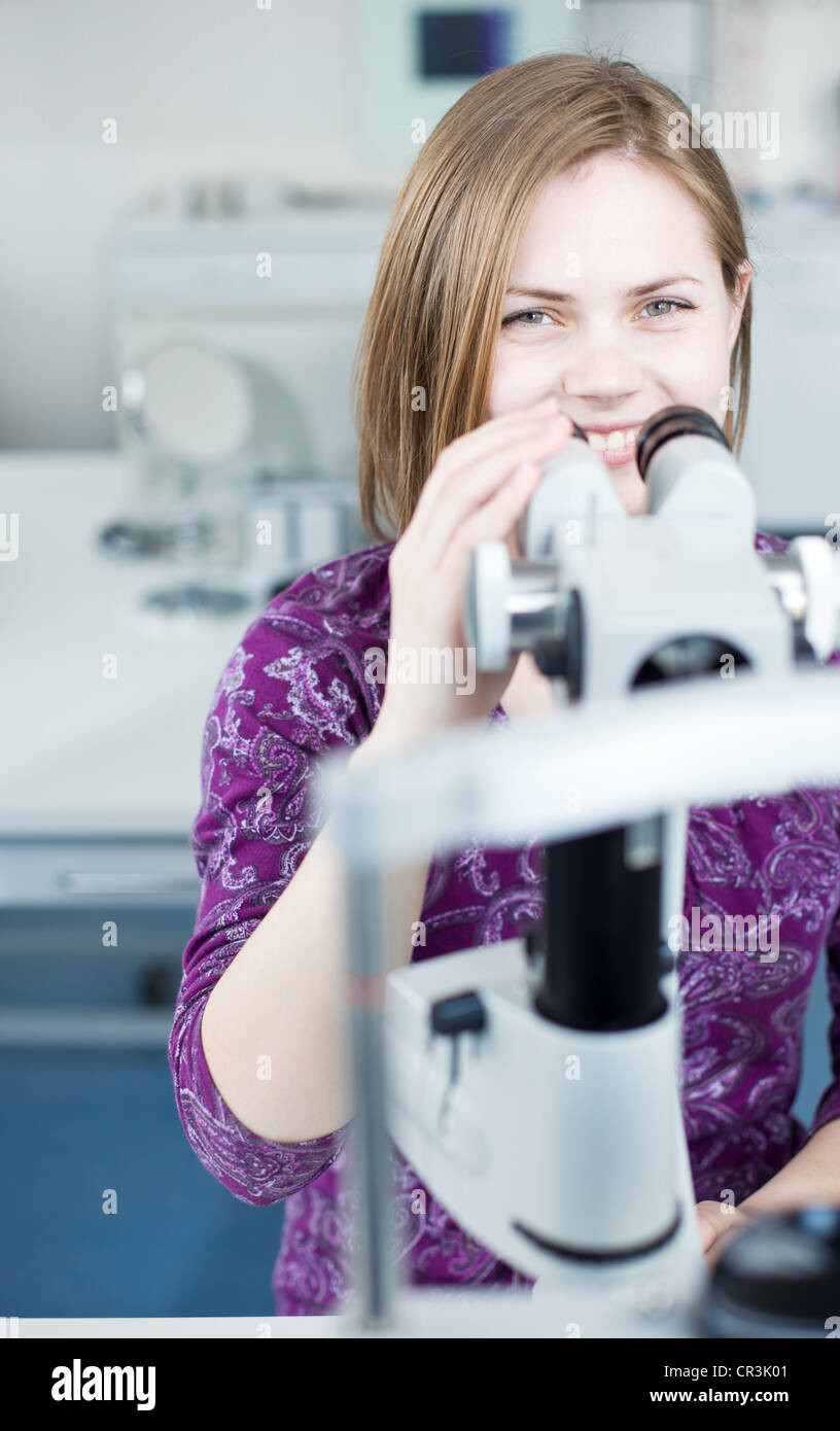 optometry concept - portrait of a young pretty optometrist using slit ...