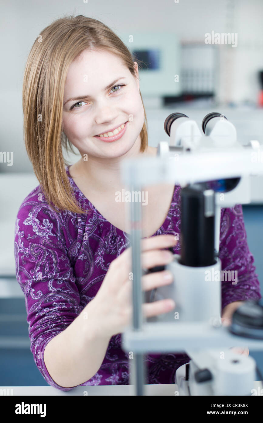 optometry concept - portrait of a young pretty optometrist using slit ...