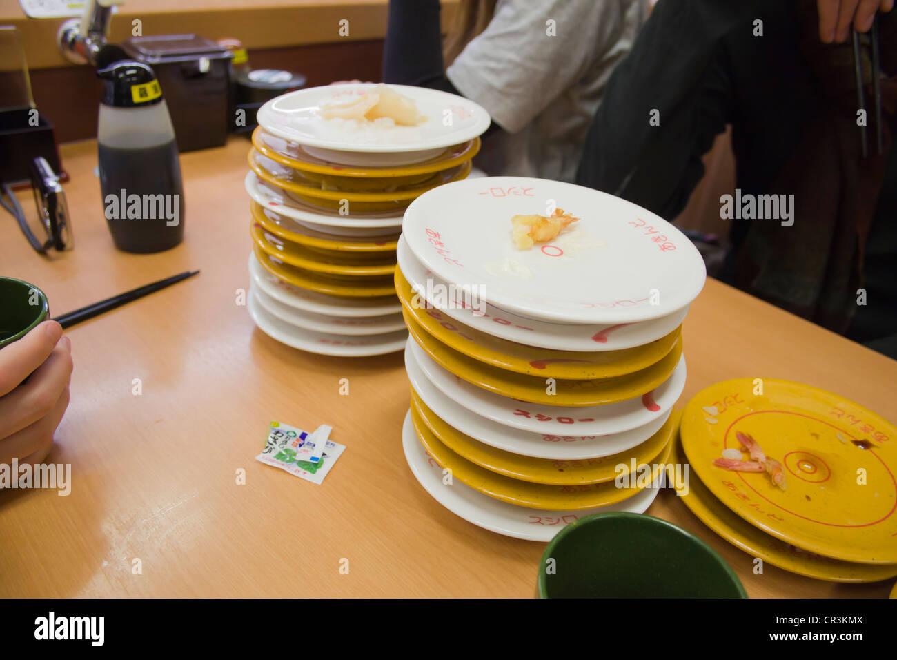 Stack of empty plates in a sushi restaurant in Japan,Asia Stock Photo ...