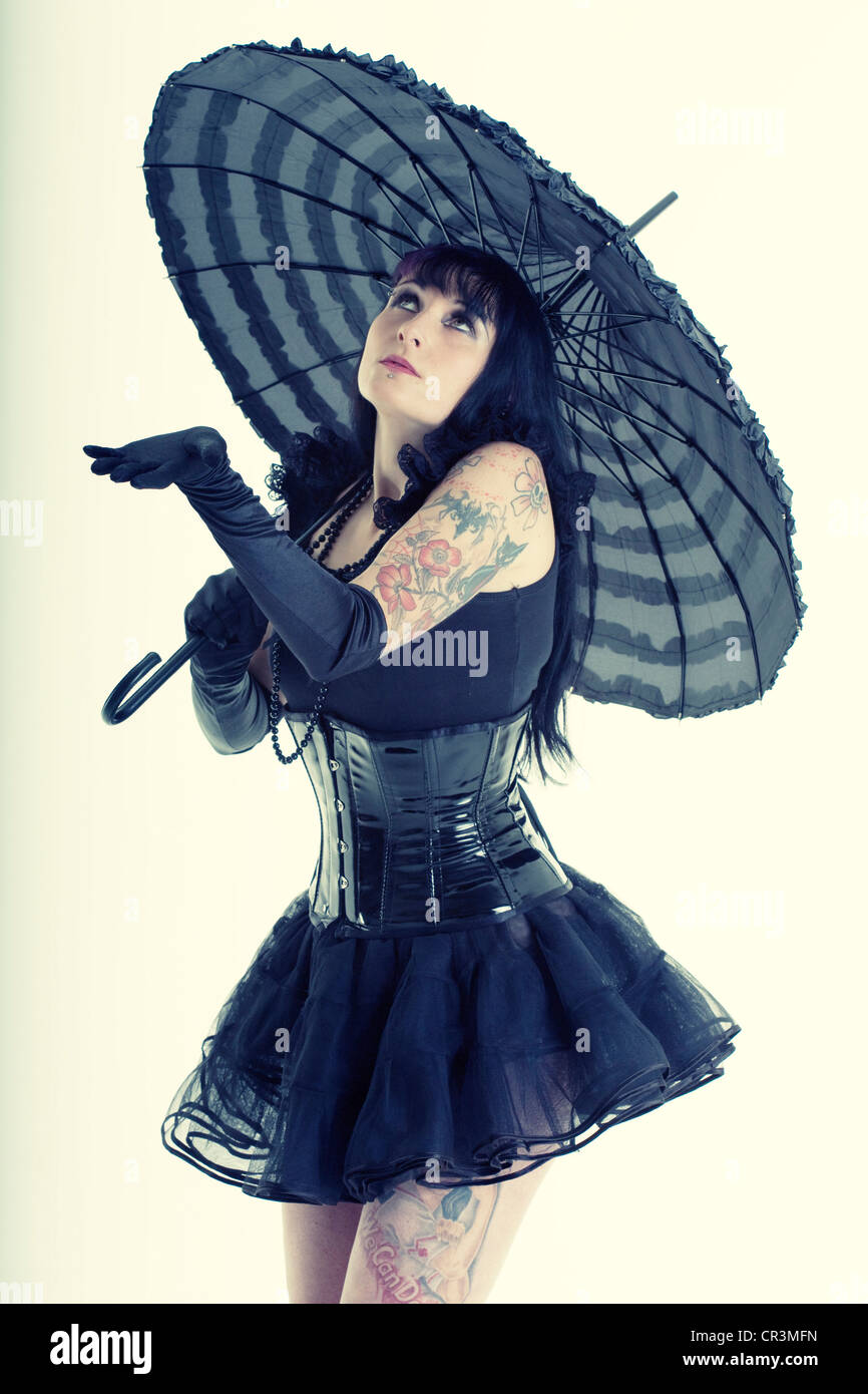 Woman, Gothic, vinyl corset, parasol, standing Stock Photo - Alamy