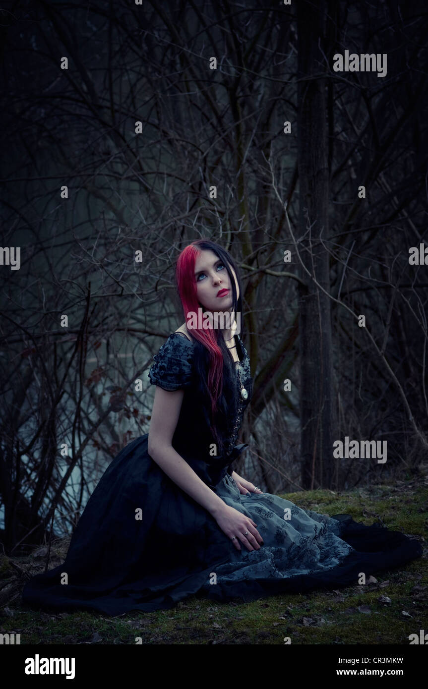 Woman, Gothic, dark-haired, kneeling, forest Stock Photo - Alamy